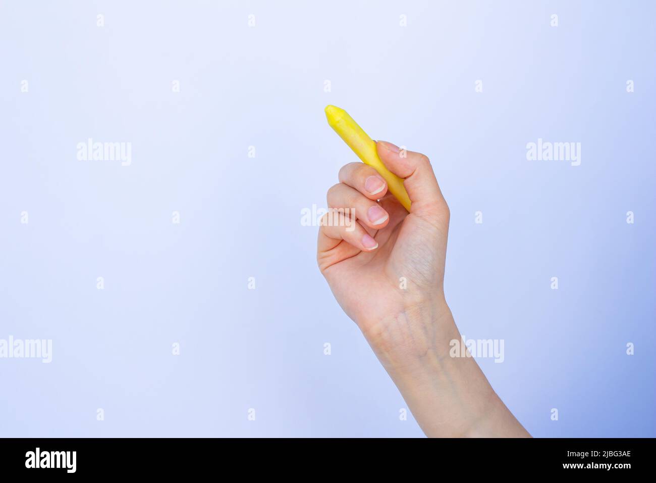 Hand holding chalk on isolated white background. Woman writing ...