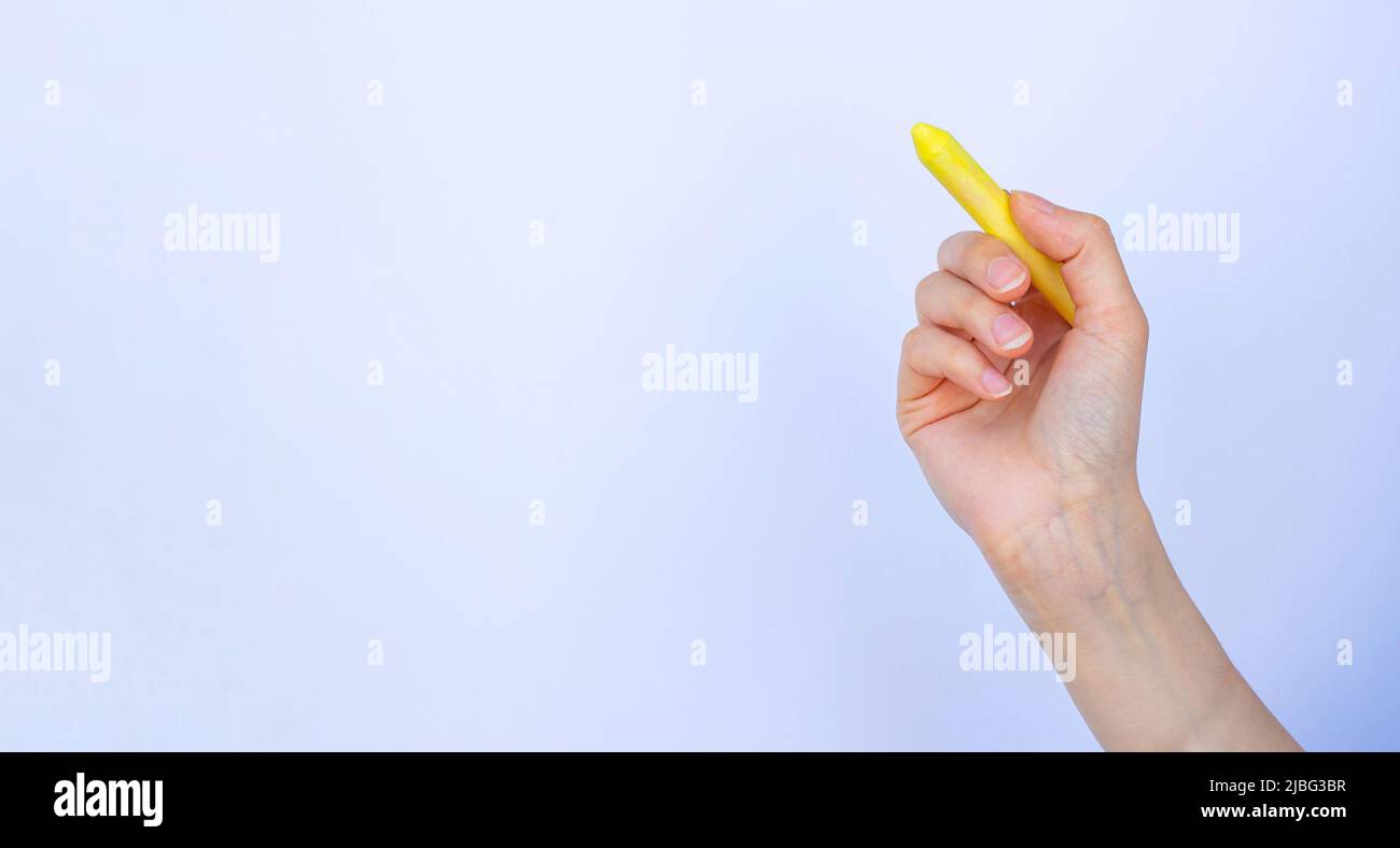 Hand holding chalk on isolated white background. Woman writing ...