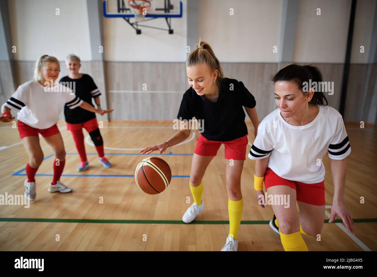 Young woman dribbling basketball hi-res stock photography and images ...