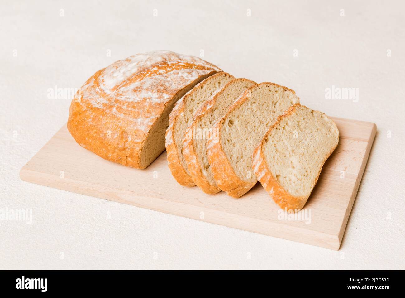 Assortment of freshly sliced baked bread with napkin on rustic table ...
