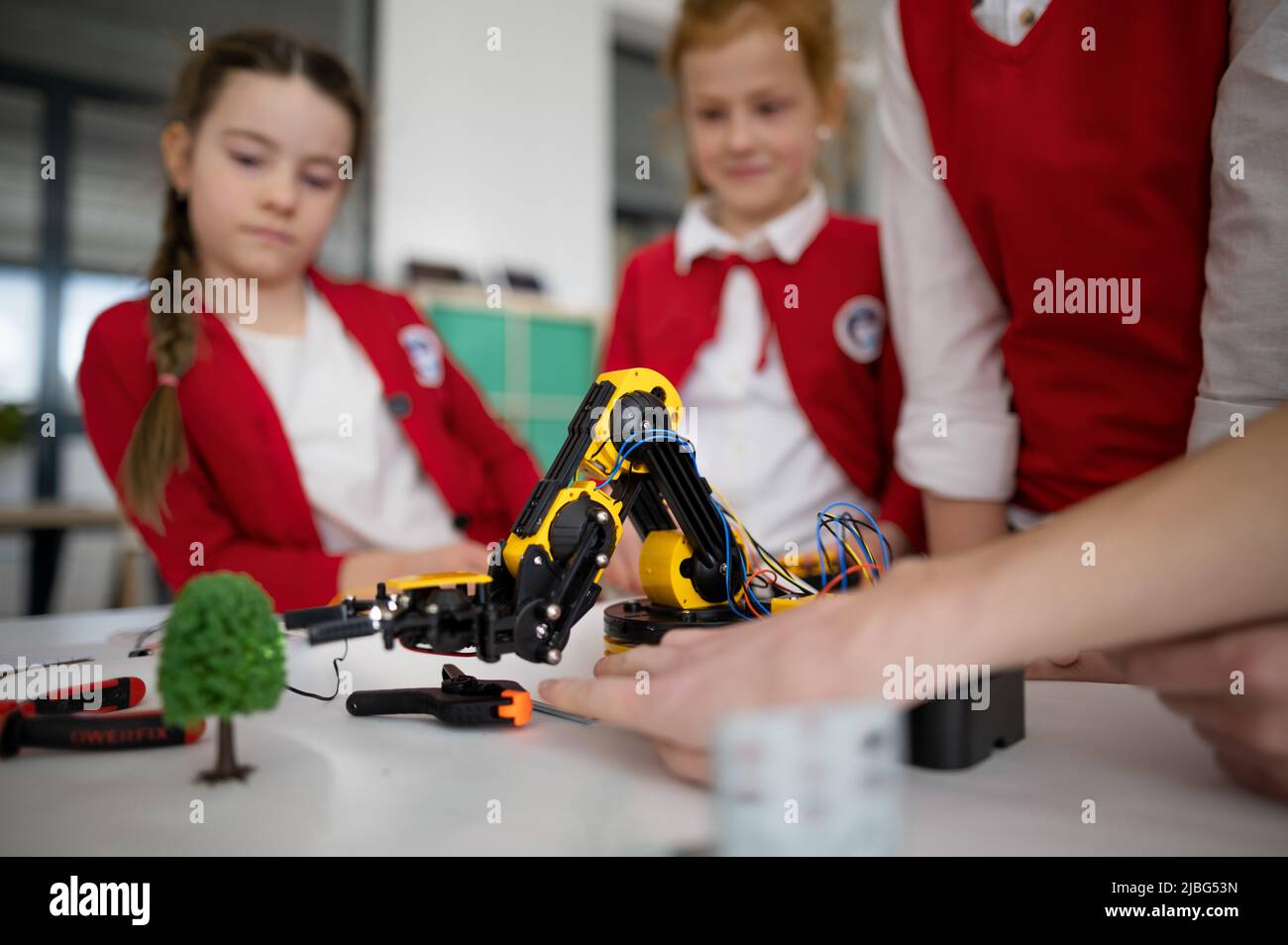Group of kids with programming electric toys and robots at robotics ...