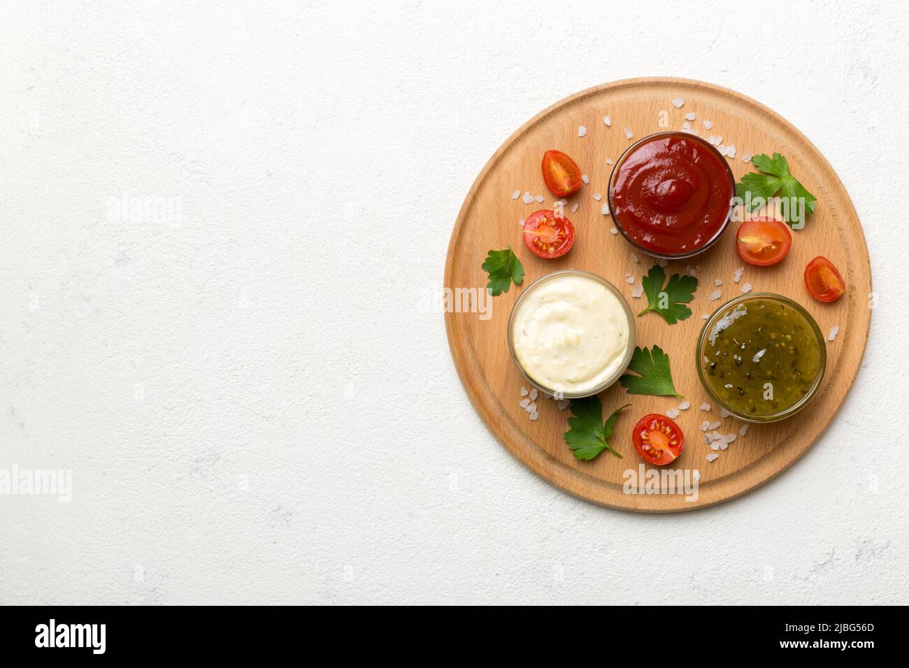 Many different sauces and herbs on table, flat lay top view. sauces on ...