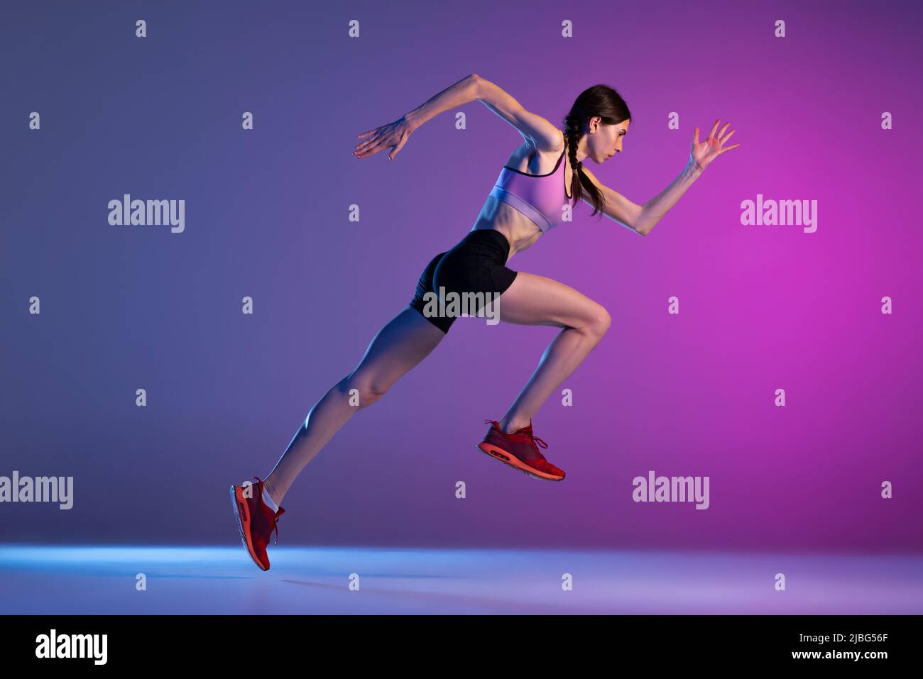 One young muscular girl, female runner or jogger training isolated on ...