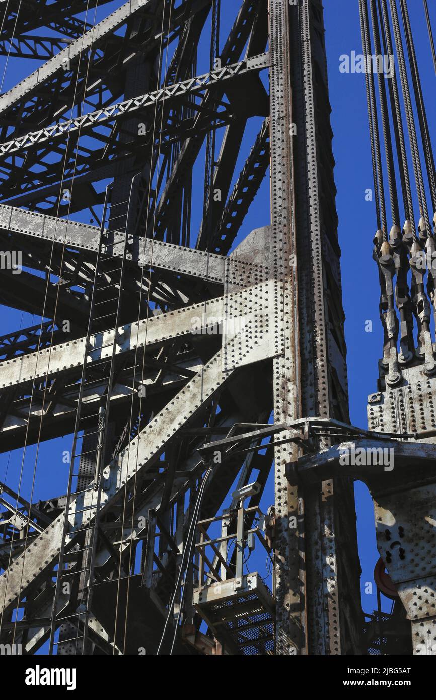 A very tall steel truss structure standing in the industrial district ...