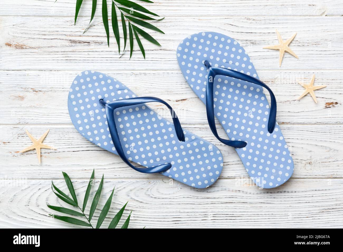 Flat lay composition with flip flops and seashell on colored background ...