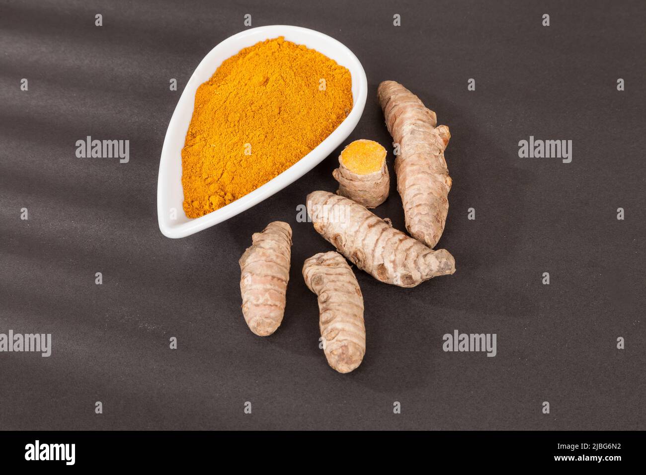 Turmeric - Curcuma longa root and turmeric powder; Photo on dark ...