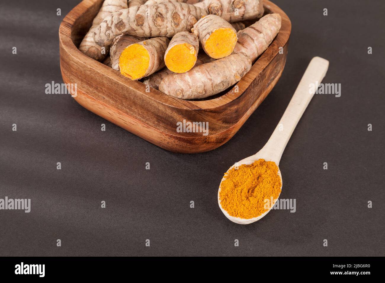 Turmeric - Curcuma longa root and turmeric powder; Photo on dark ...