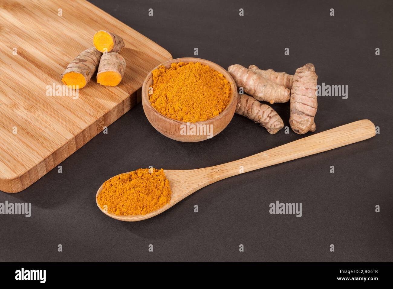 Turmeric - Curcuma longa root and turmeric powder; Photo on dark ...