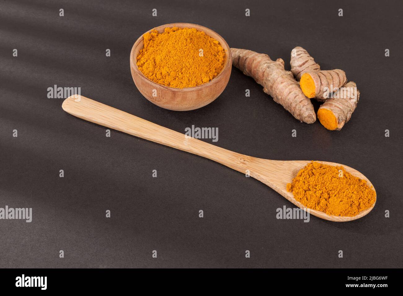Turmeric - Curcuma longa root and turmeric powder; Photo on dark ...