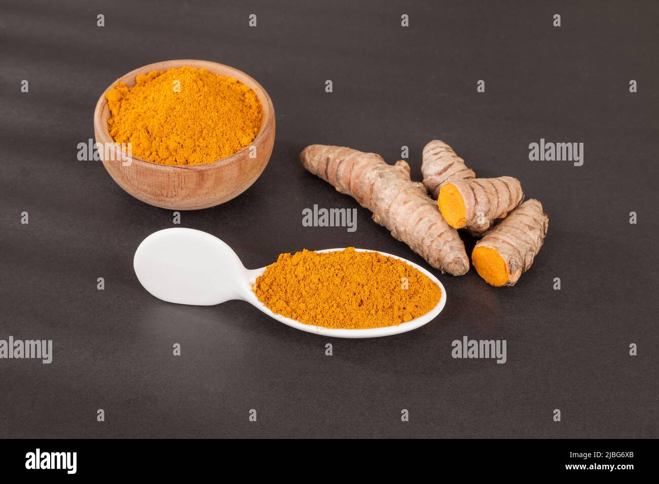 Turmeric - Curcuma longa root and turmeric powder; Photo on dark ...