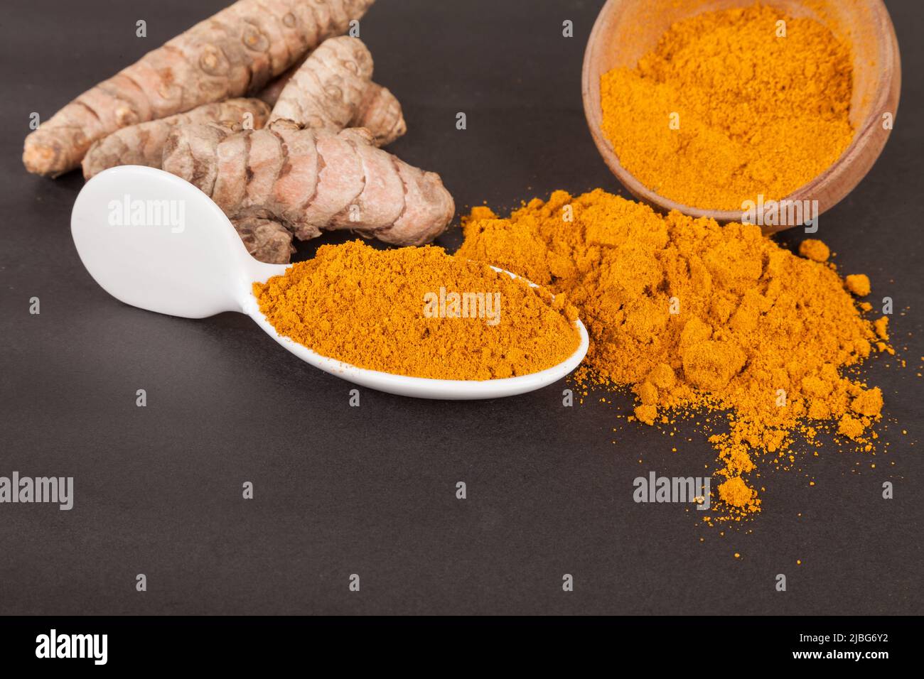 Turmeric - Curcuma longa root and turmeric powder; Photo on dark ...