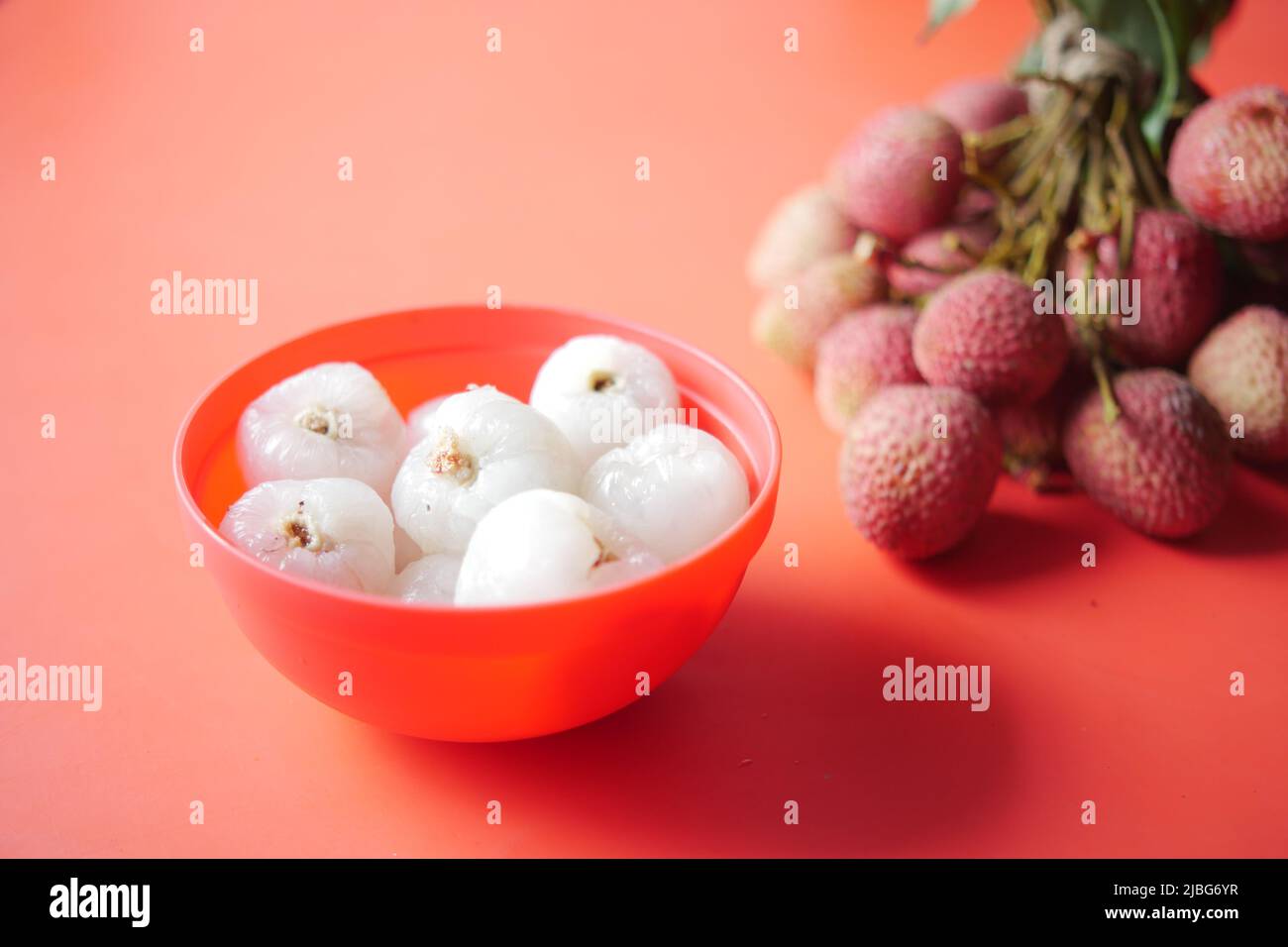Lychee fruits in a red color bowl Stock Photo - Alamy