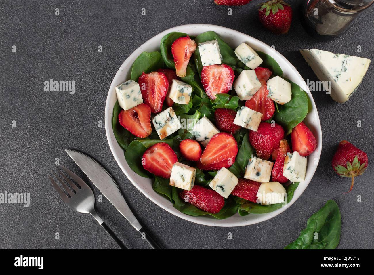 Healthy salad with strawberries, spinach and cheese dor blue, dressed ...
