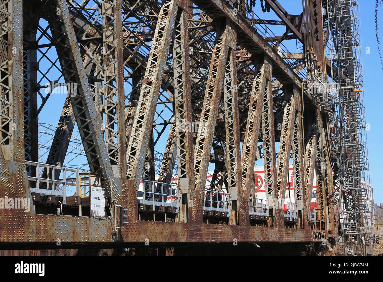 A vintage rusty steel truss frame bridge spanning a river Stock Photo ...