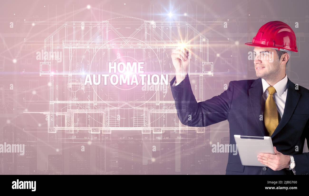 Handsome architect drawing with helmet Stock Photo - Alamy