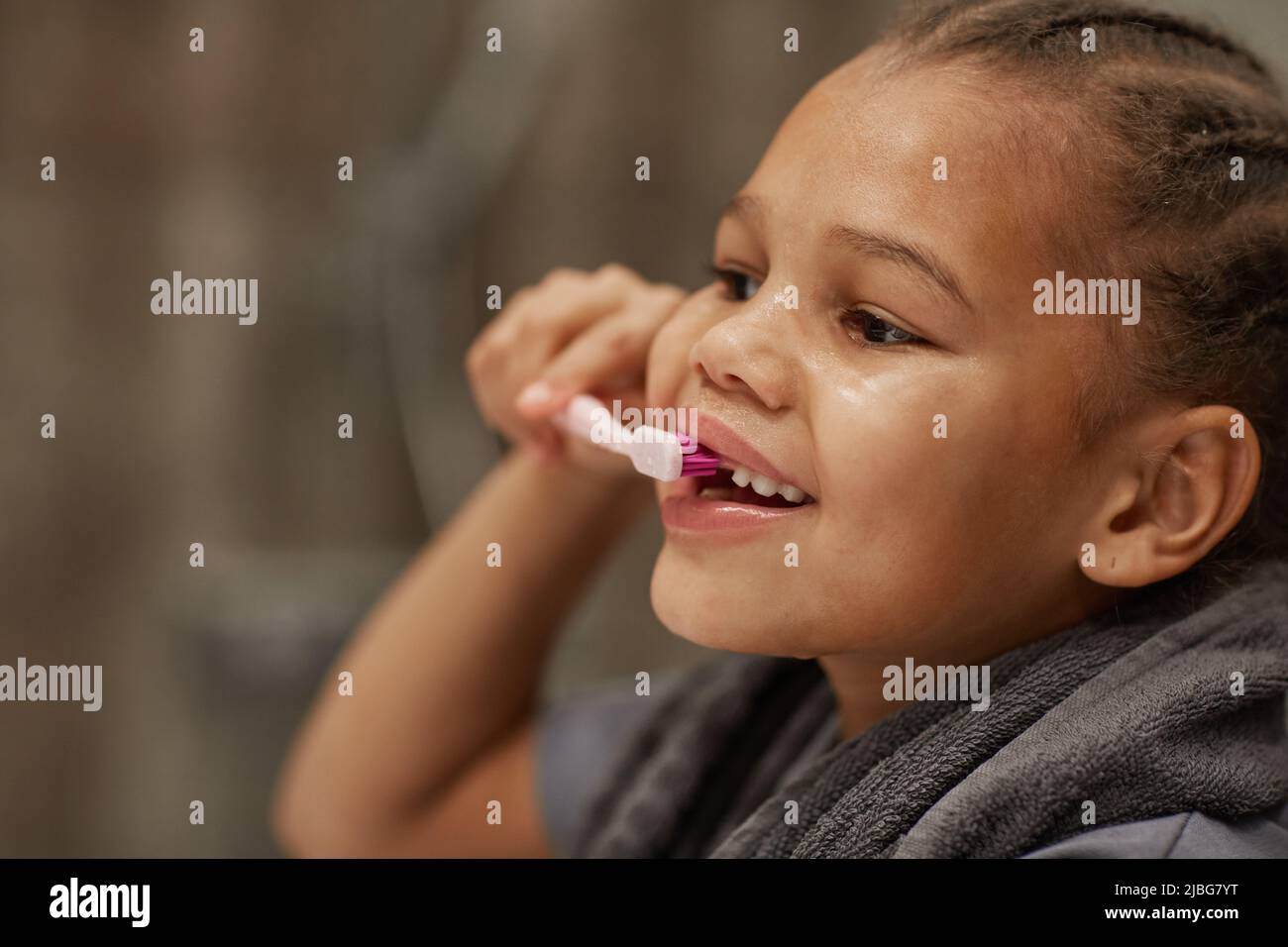 Close up of little black girl brushing teeth with pink toothbrush good ...