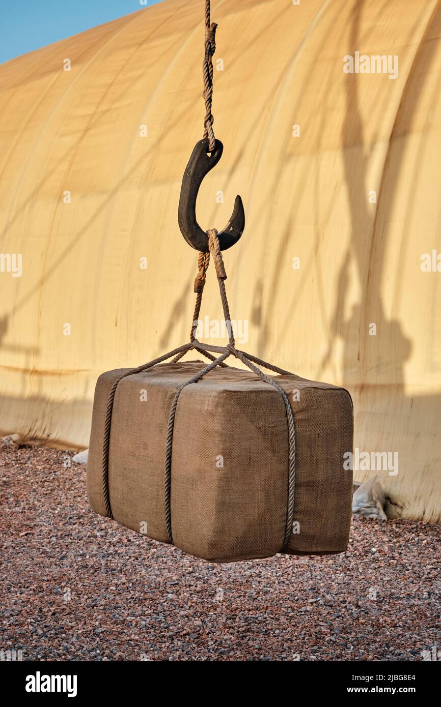 Hook of an ancient crane lifting a load Stock Photo - Alamy