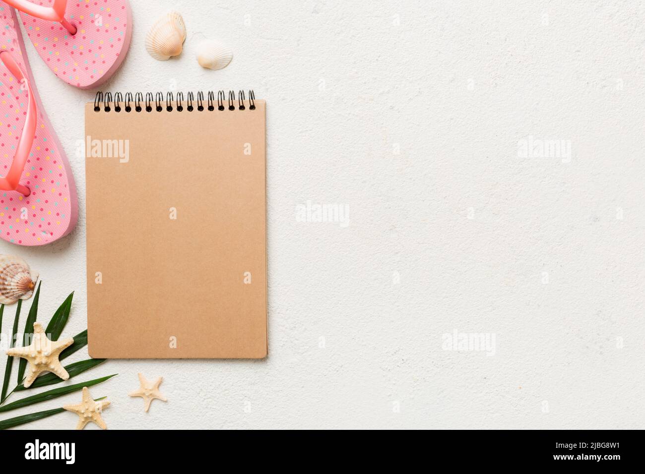 Blank writing book with summer beach accessories on background, copy ...