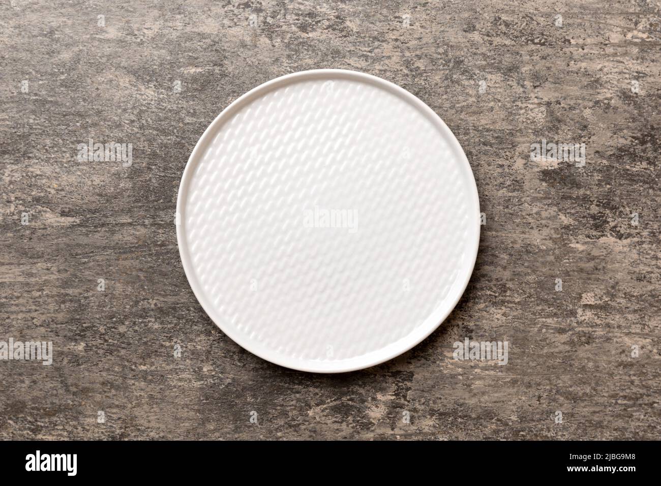 Top view of empty light plate on cement background. Empty space for ...