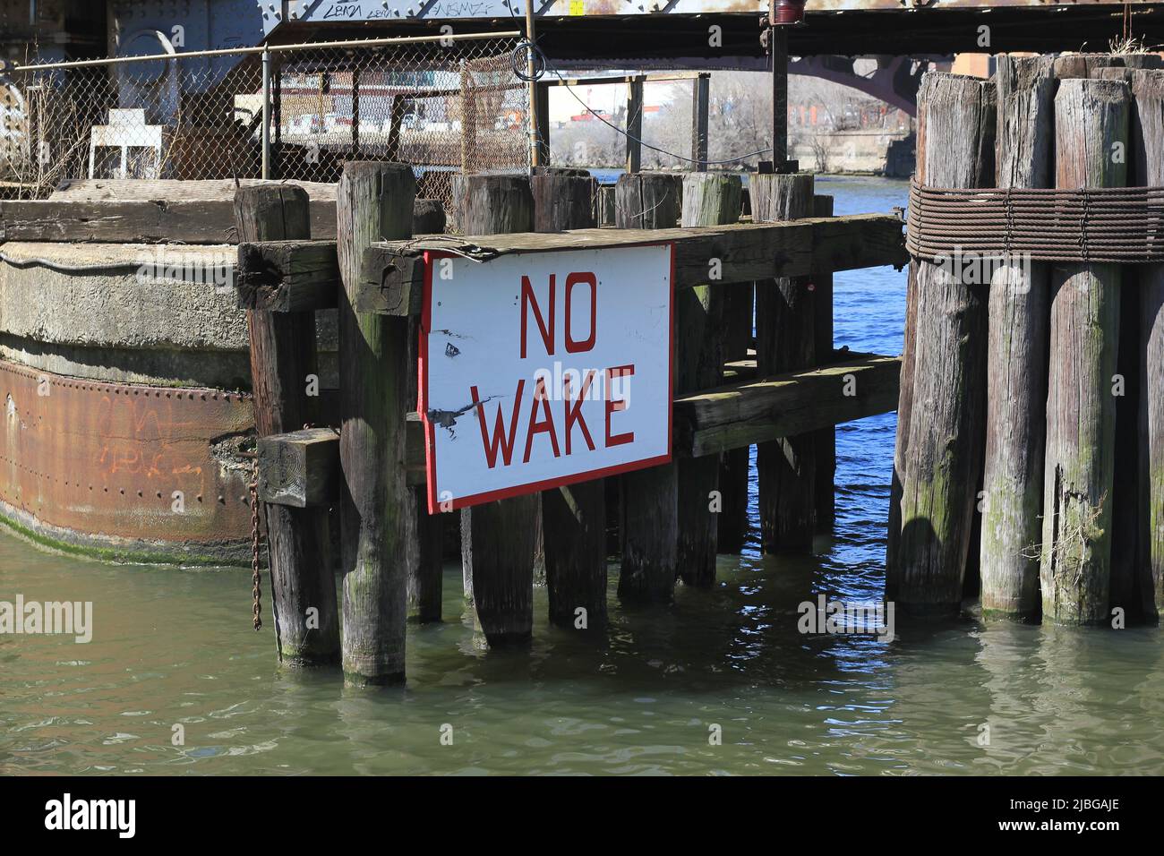No Wake sign hanging on the pier Stock Photo - Alamy