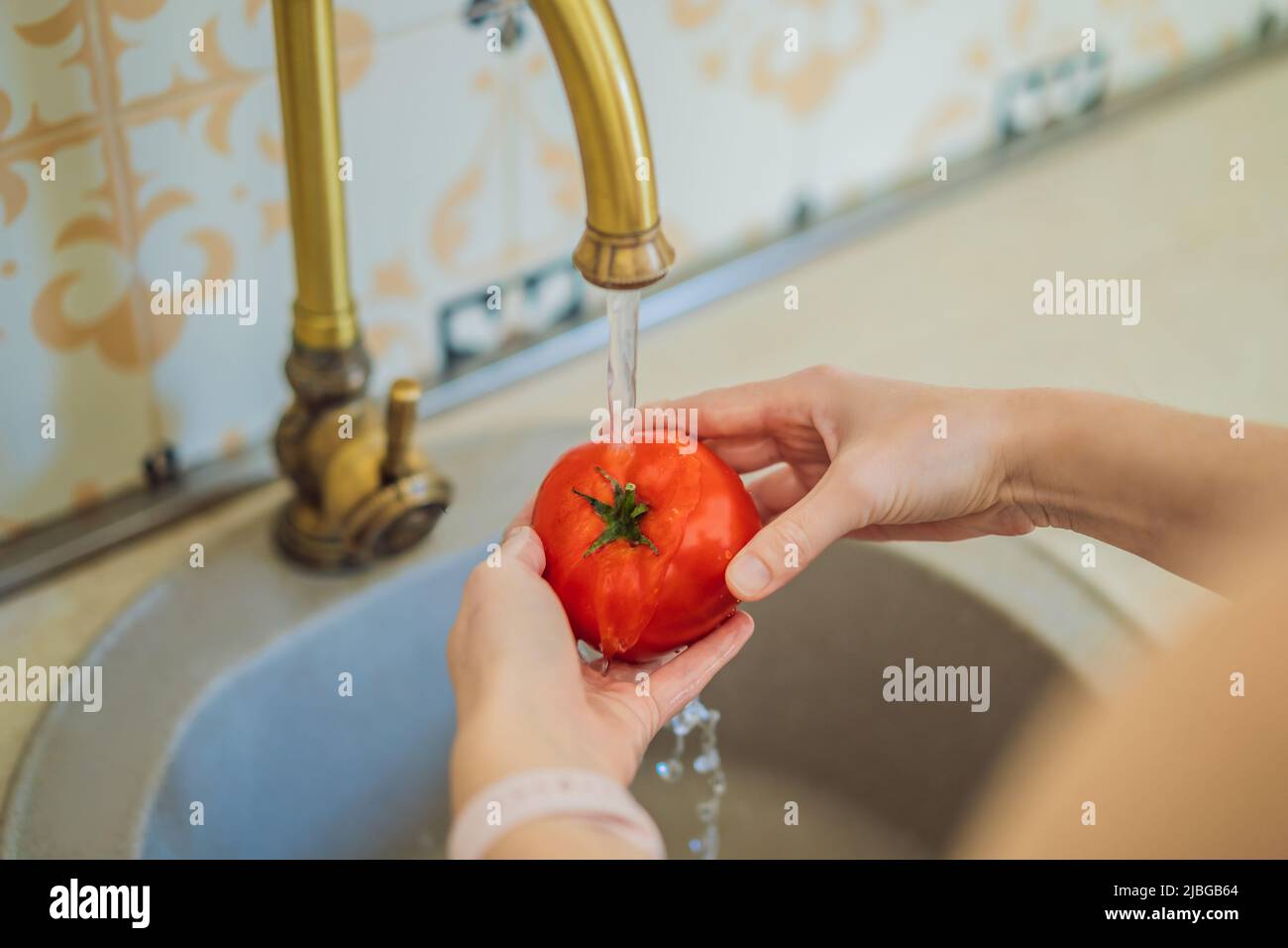 Close-up Of A Woman Washing Tomato In Running Water Under Tap Stock ...