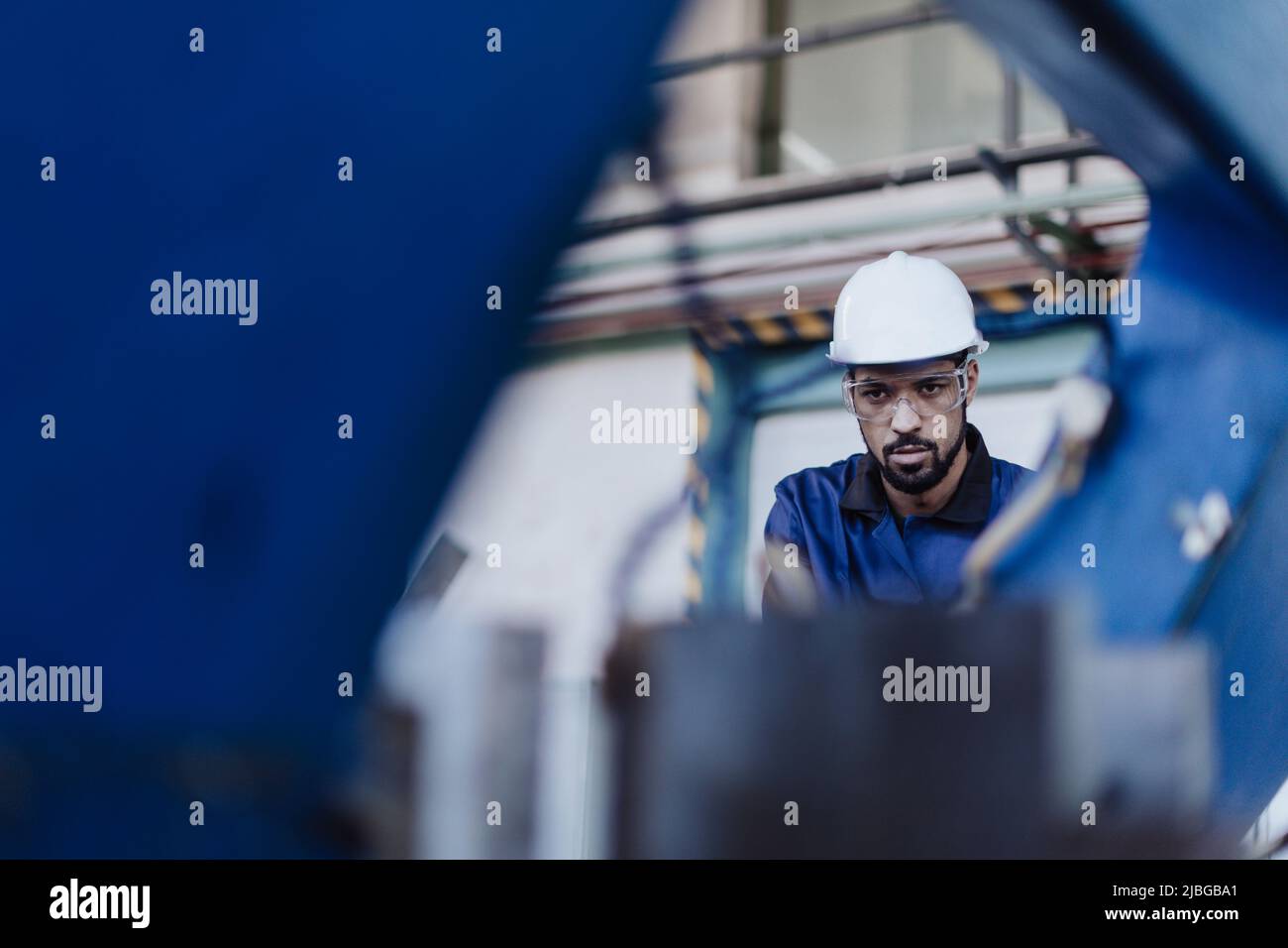 Factory male worker in plant production drilling at metal machine in ...