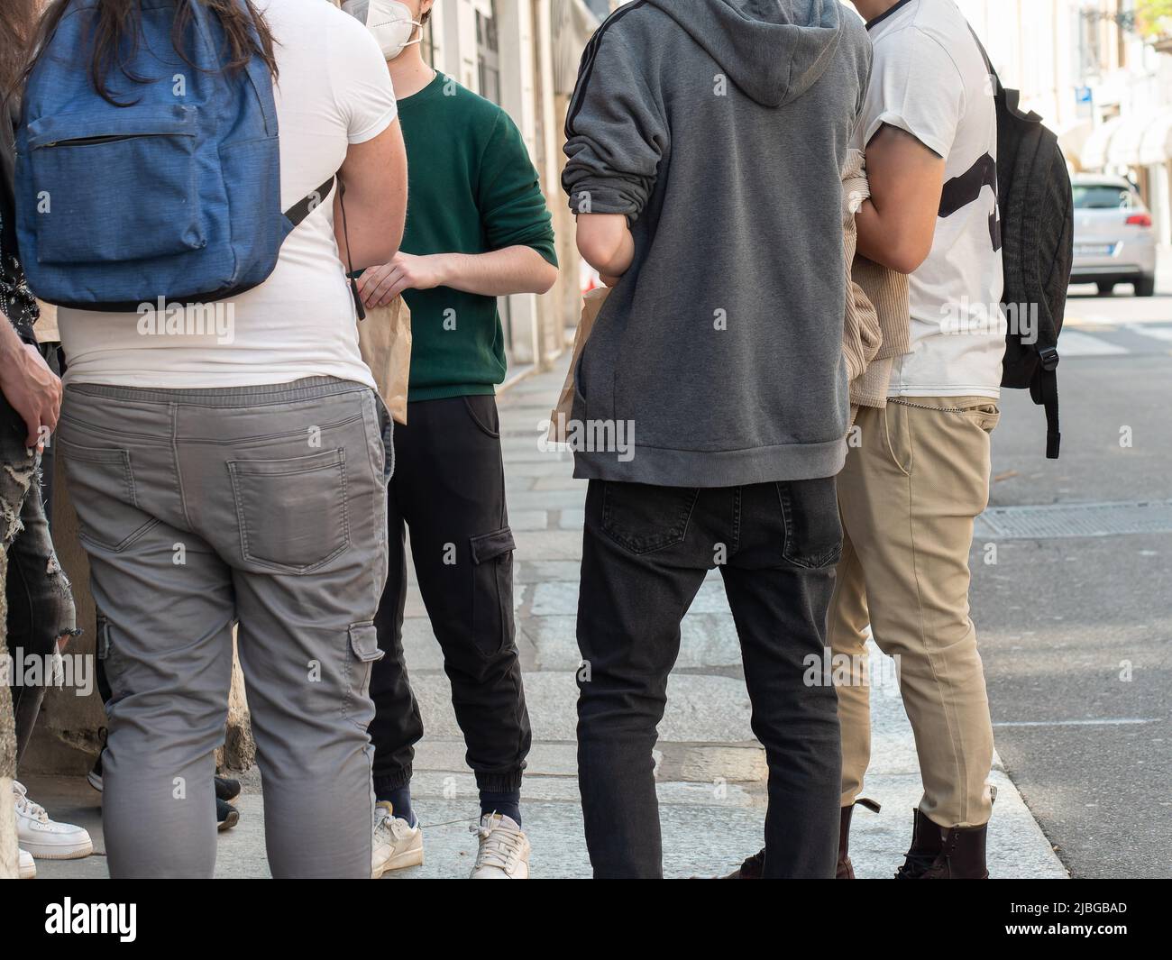 Group of Teens in Group Talking on the Sidewalk of a City Street Stock ...