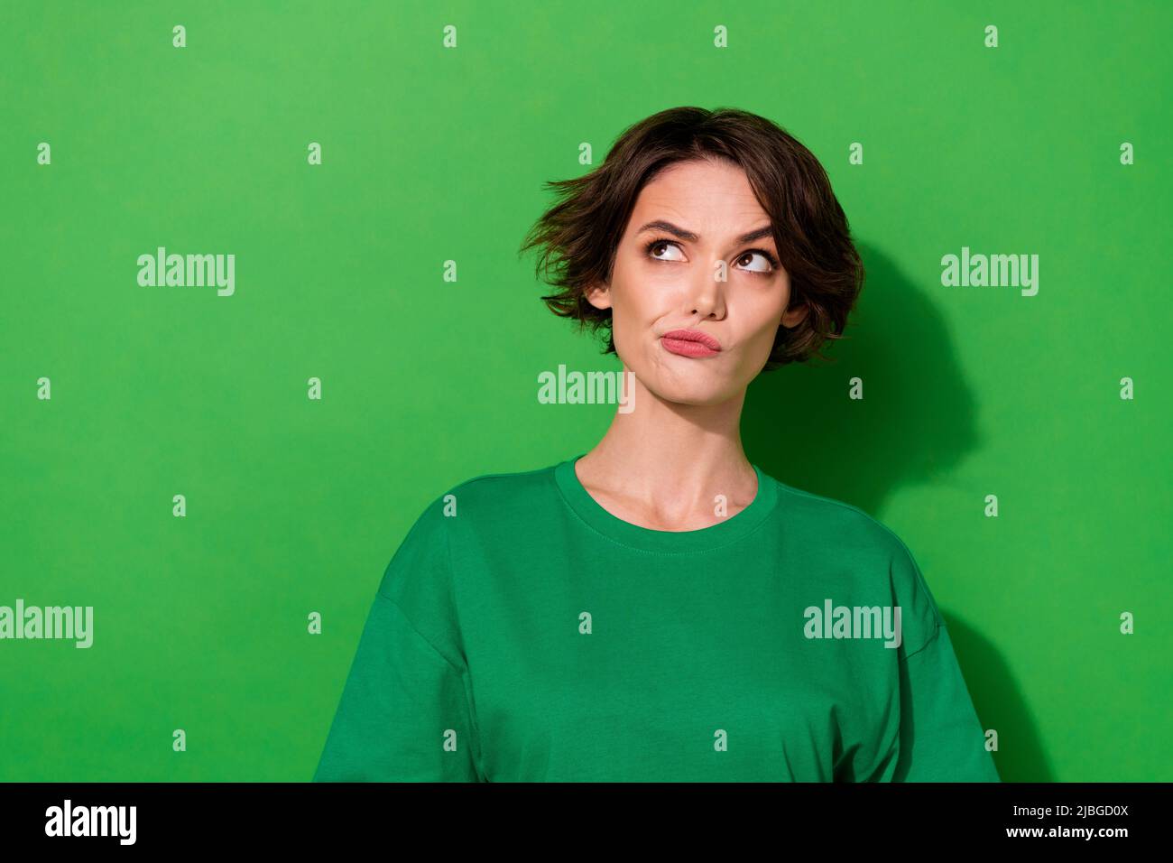Photo of doubtful unsure young lady dressed casual t-shirt looking ...