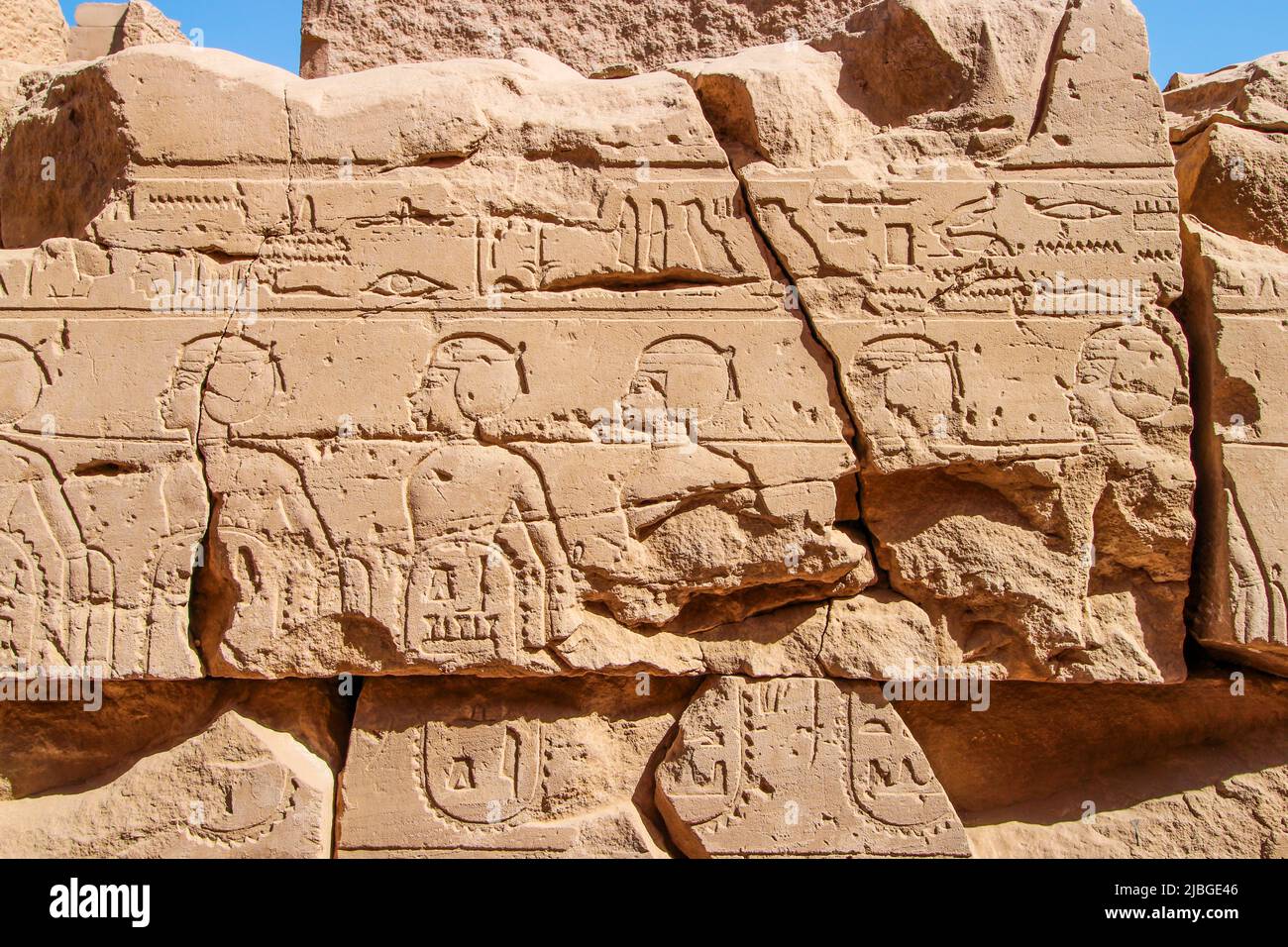 Old Egypt hieroglyphs carved on the stone wall in The Karnak Temple ...