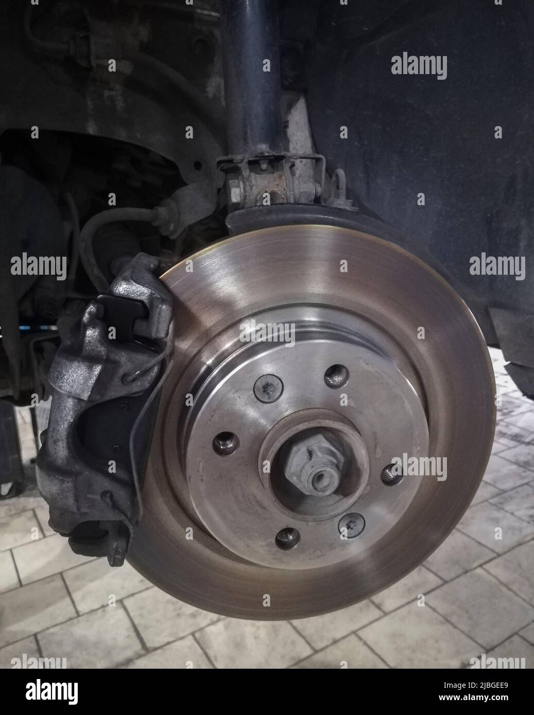 Brake disc of a passenger car in a car service on a lift Stock Photo ...