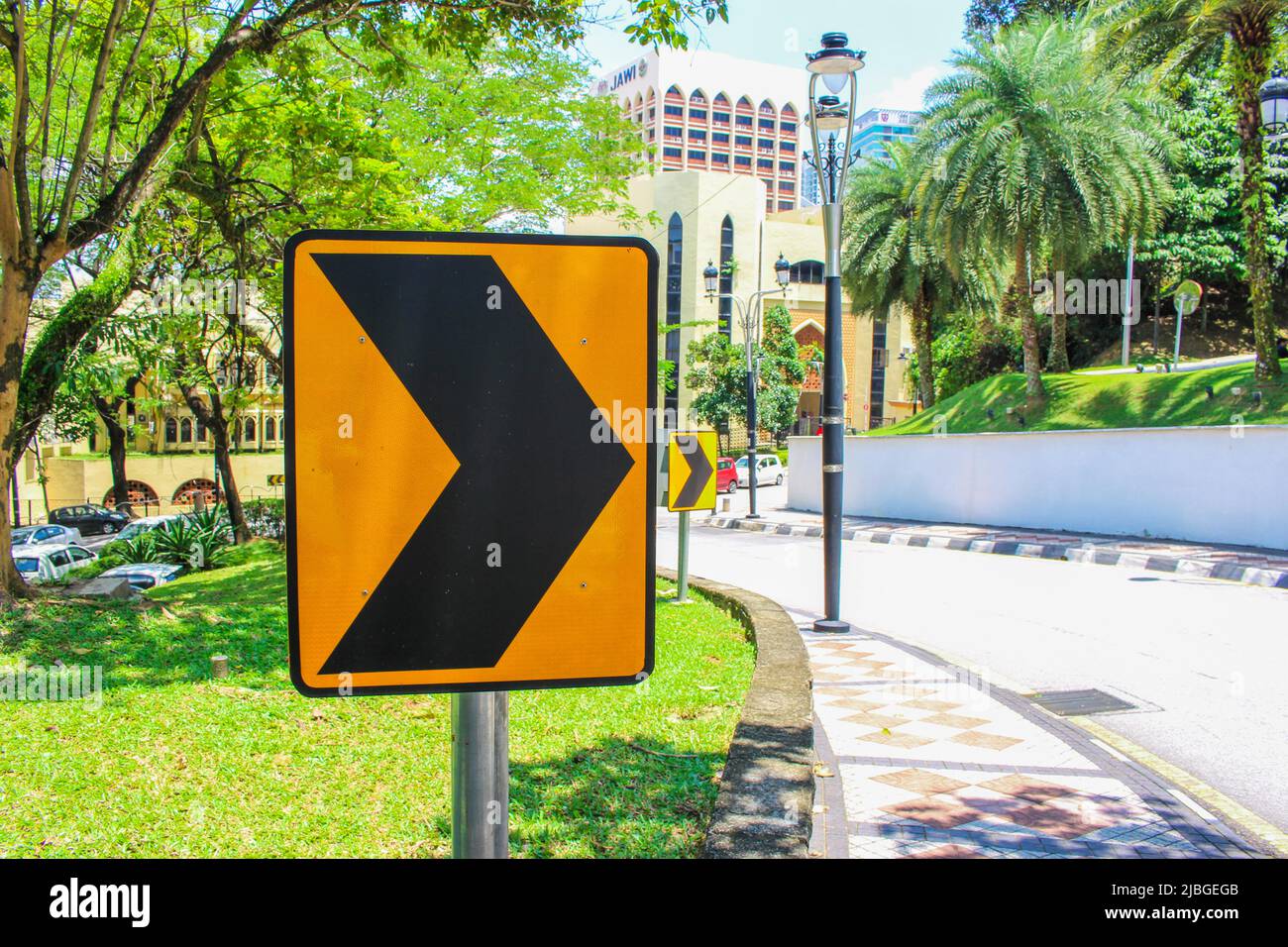 Curve road sign (orange and black colour) that pointing right direction ...
