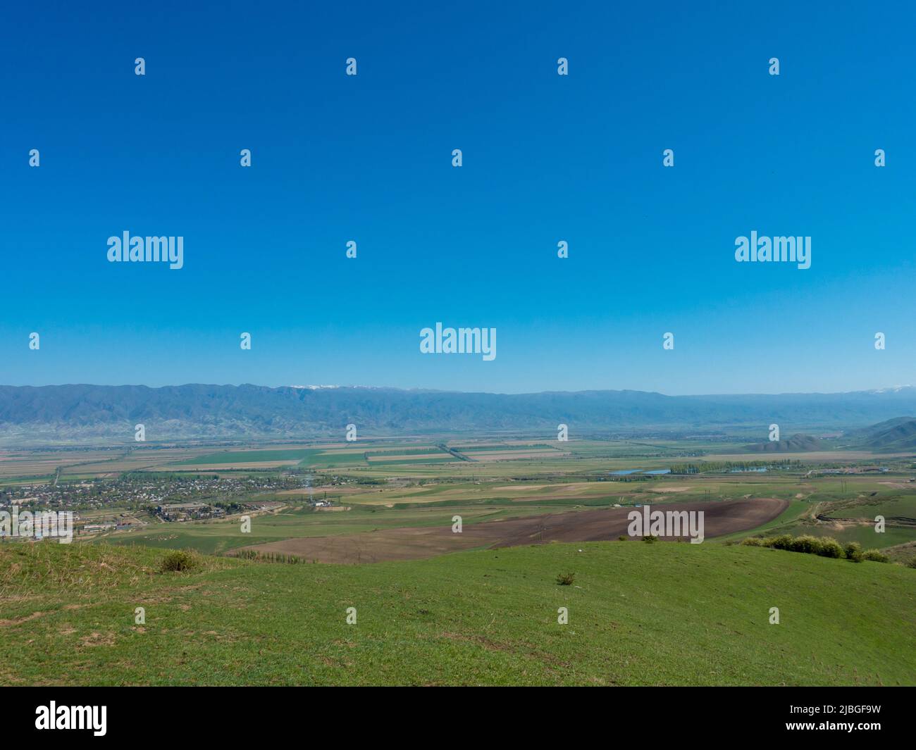 Green slopes and blue skies. Kyrgyzstan Stock Photo - Alamy
