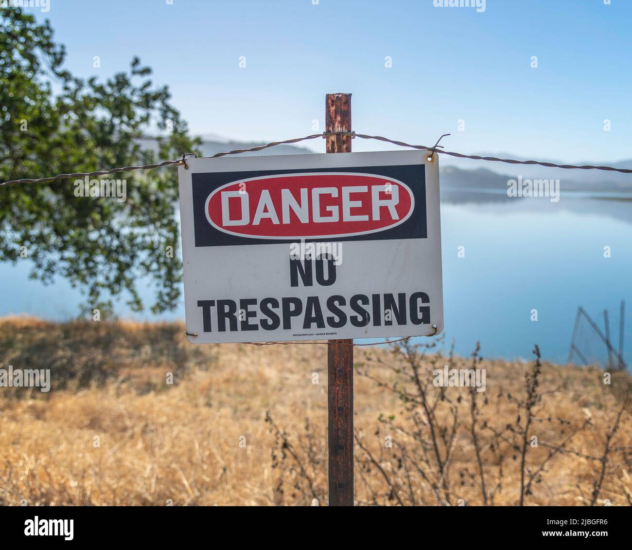 Close up of a posted danger no trespassing sign Stock Photo - Alamy