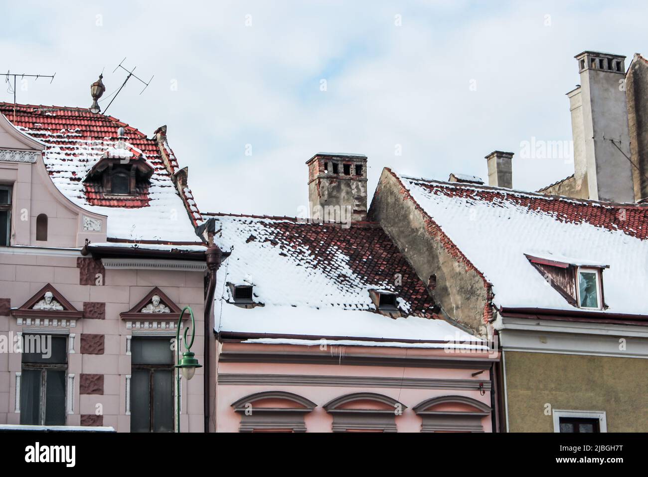 Top of old european buildings with window and orange tile roofs with ...