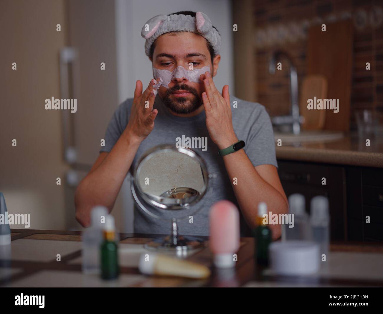 Men's beauty concept. caucAsian guy checking his skin. man looking into ...