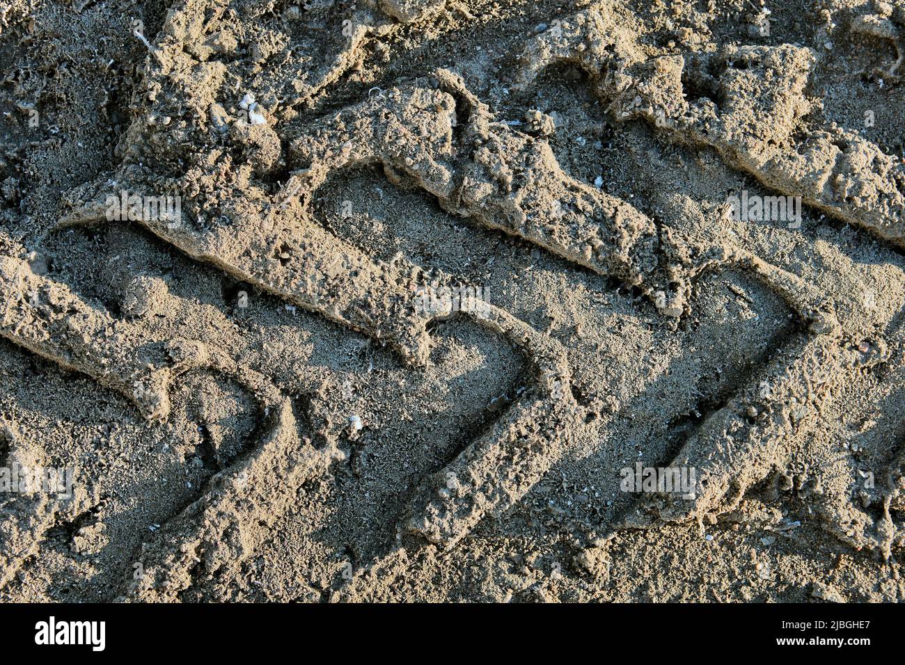 Tread track of wheeled tractor on frozen dirt road, texture for ...