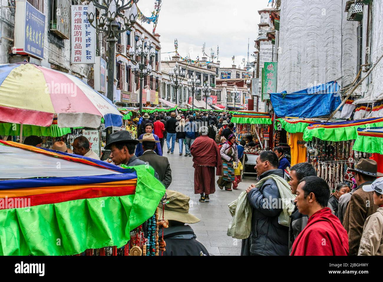 Tibetans and tourists walking through the famous Barkhor Street in ...