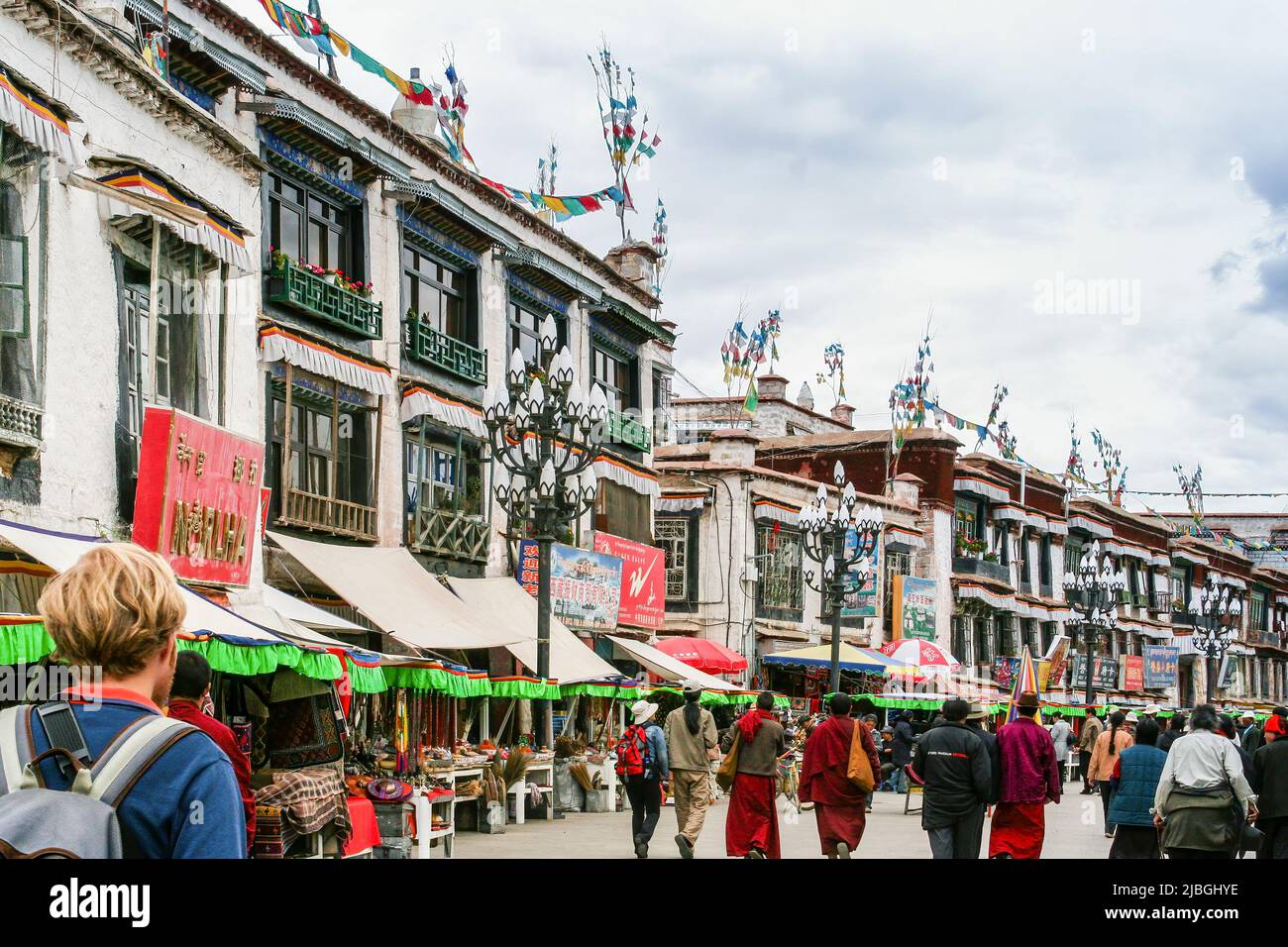 Tibetans and tourists walking through the famous Barkhor Street in ...