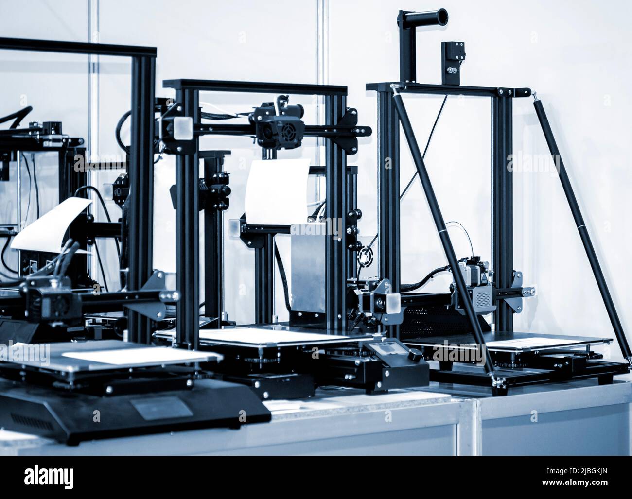 Several empty non-printing 3D printers on table. 3D printer with empty ...