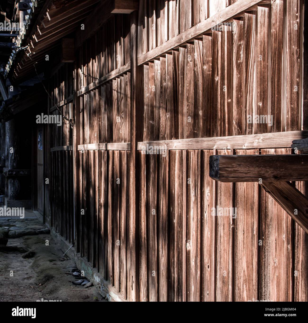 The close up of wooden wall exterior of old Japanese house in the shade ...