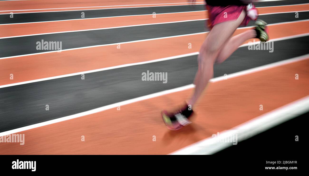 Runners running a race around a track with lines Stock Photo - Alamy