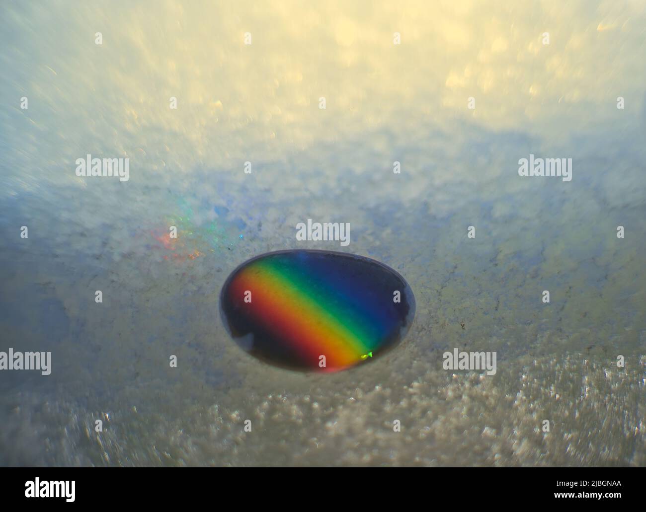 Early spring Zen rainbow stone on ice. Concept of onset of spring Stock ...