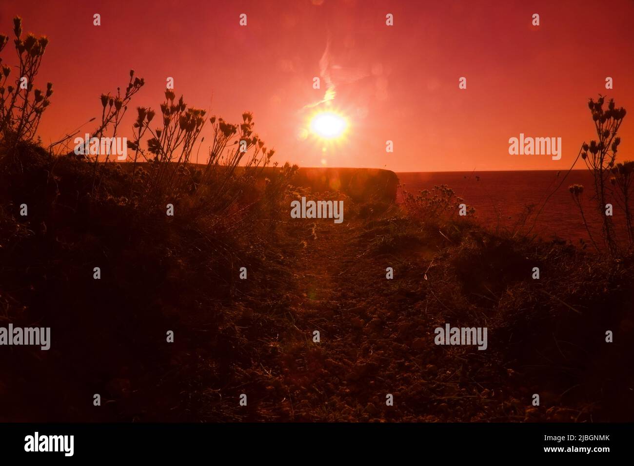 The disk of the setting sun with rays and solar flare ("spot ...