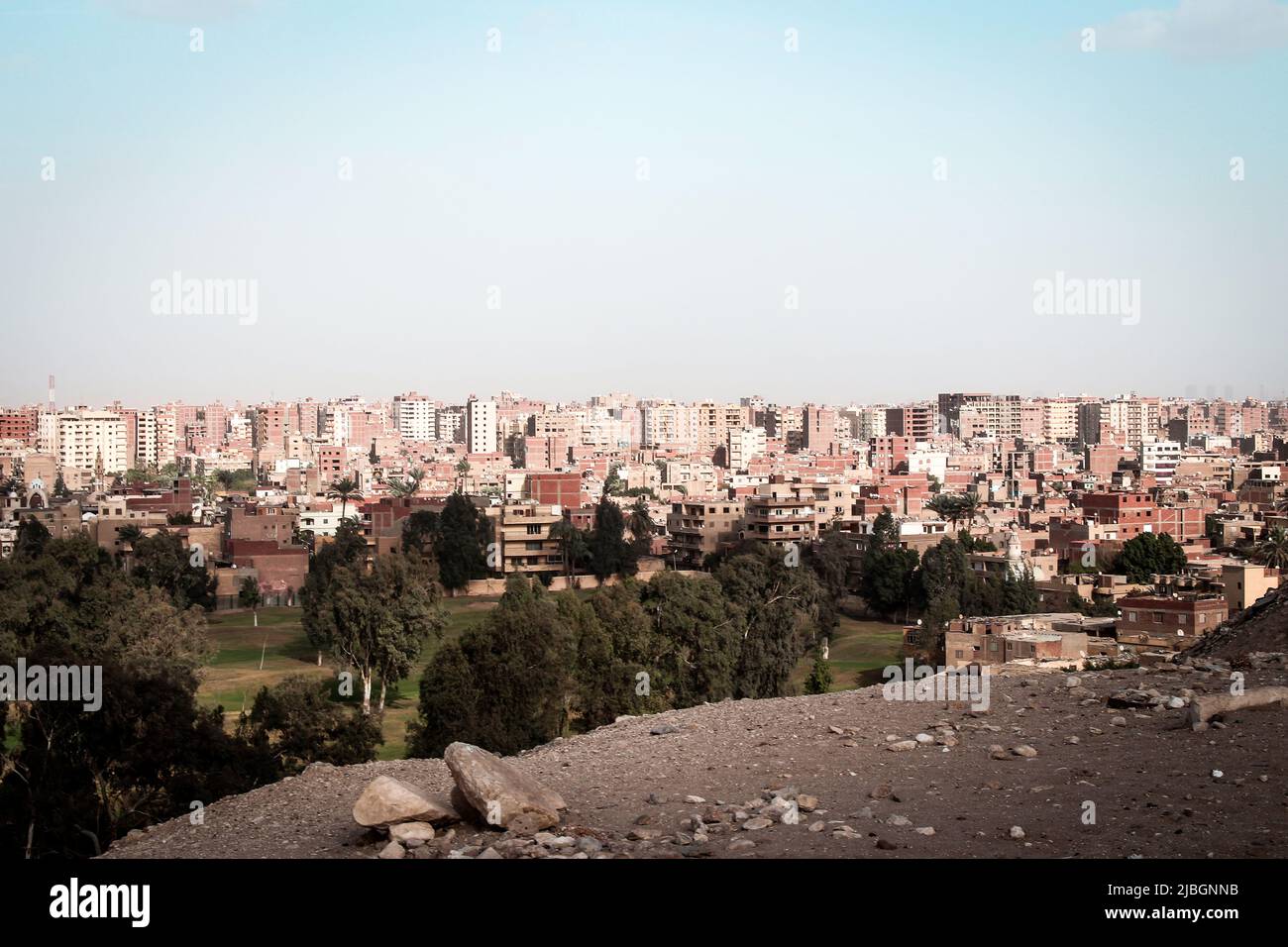 Scenic cityscape of Giza in distance from the view of Giza Pyramid ...