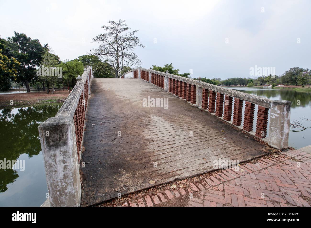 Old and sooty stone bridge in Ayutthaya Historical Park in cloudy day ...