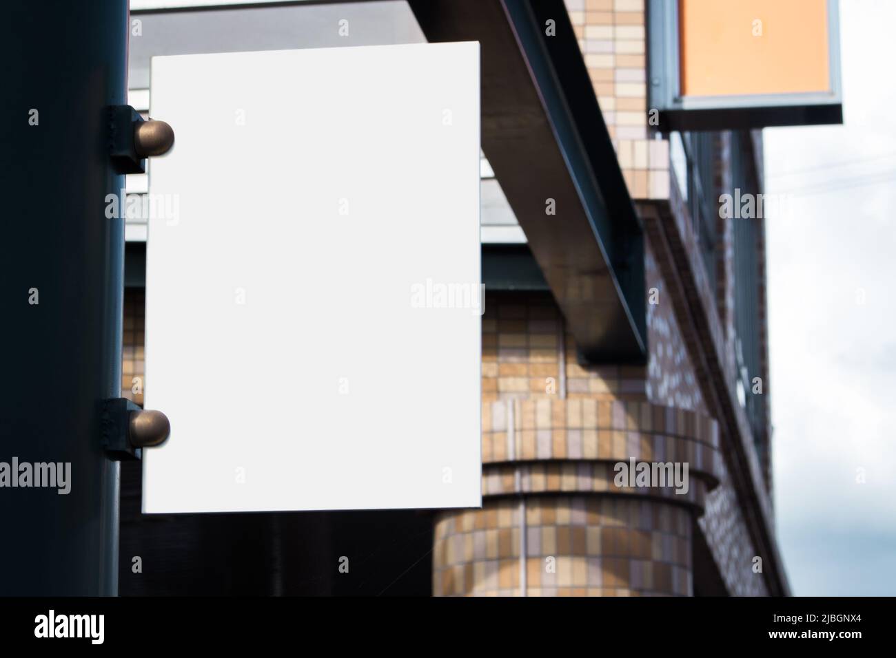 White blank sign with pole on the sidewalk. The sign is old and its ...