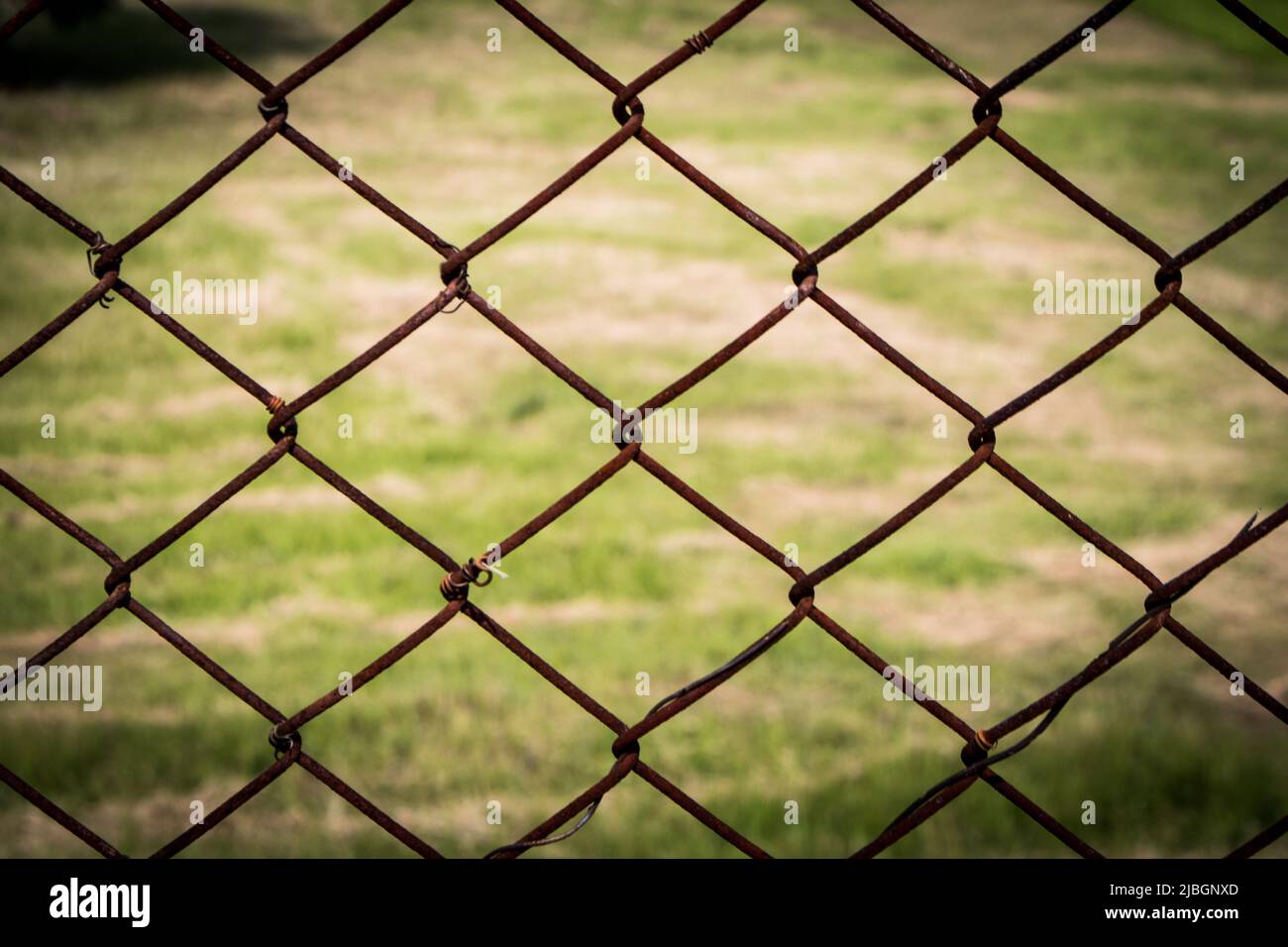 The close up of brown wire fence (barricade) which is hardly rusted in ...