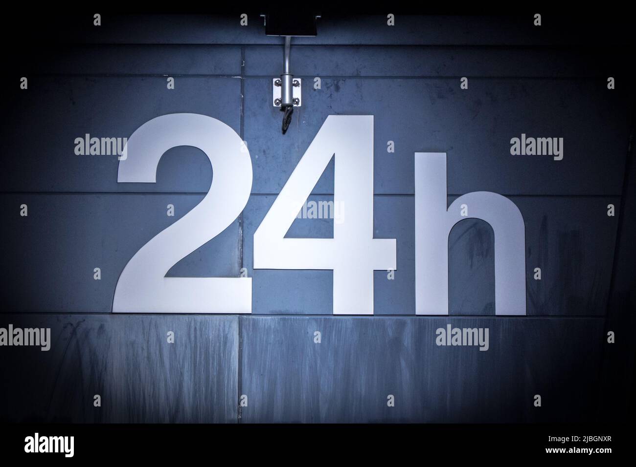 Old 24 hours shop sign which is lighted up in the spooky mood at night ...