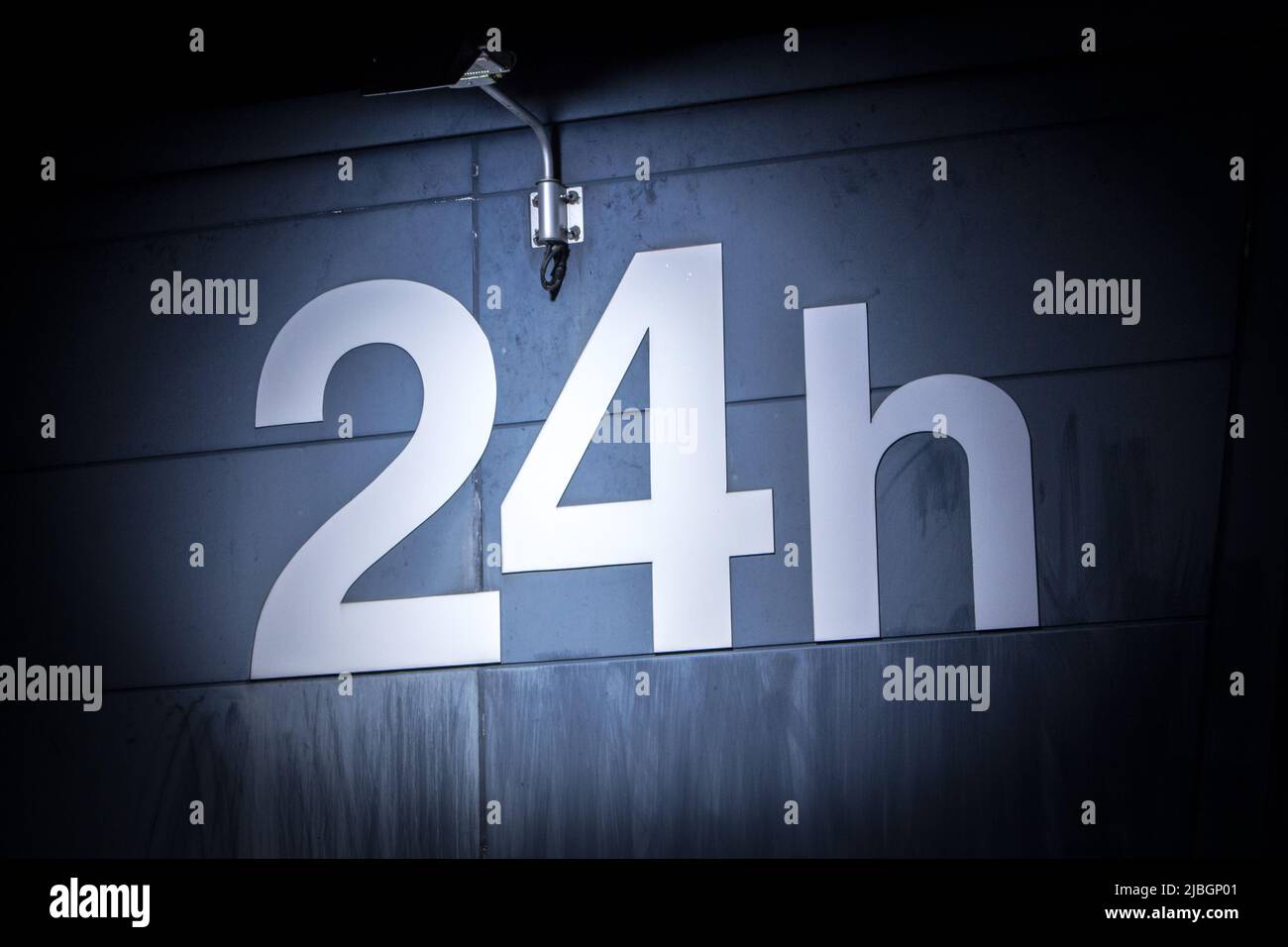 Old 24 hours shop sign which is lighted up in the spooky mood at night ...
