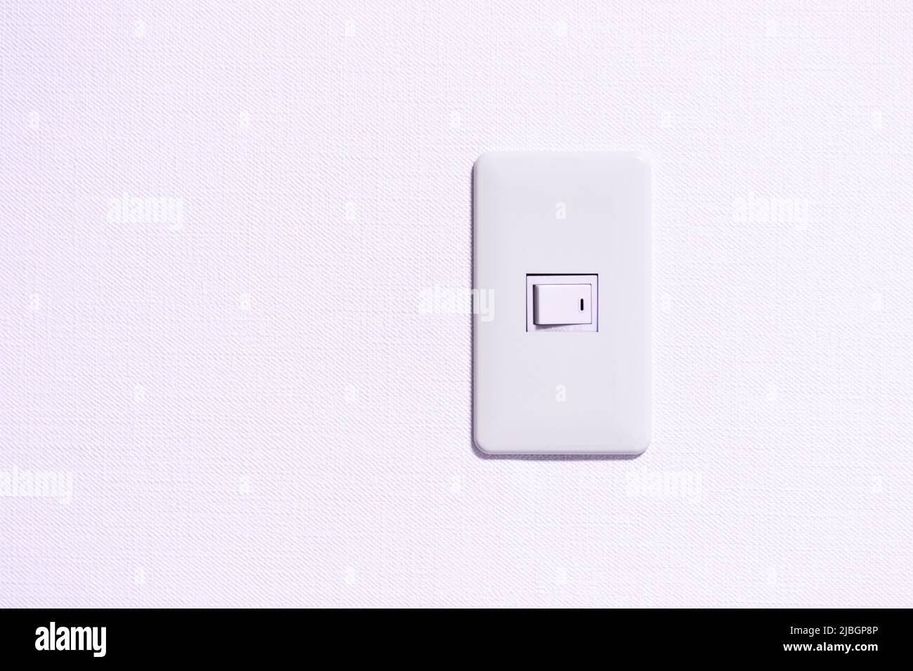 Simple light switch in room which is installed on the white coloured ...